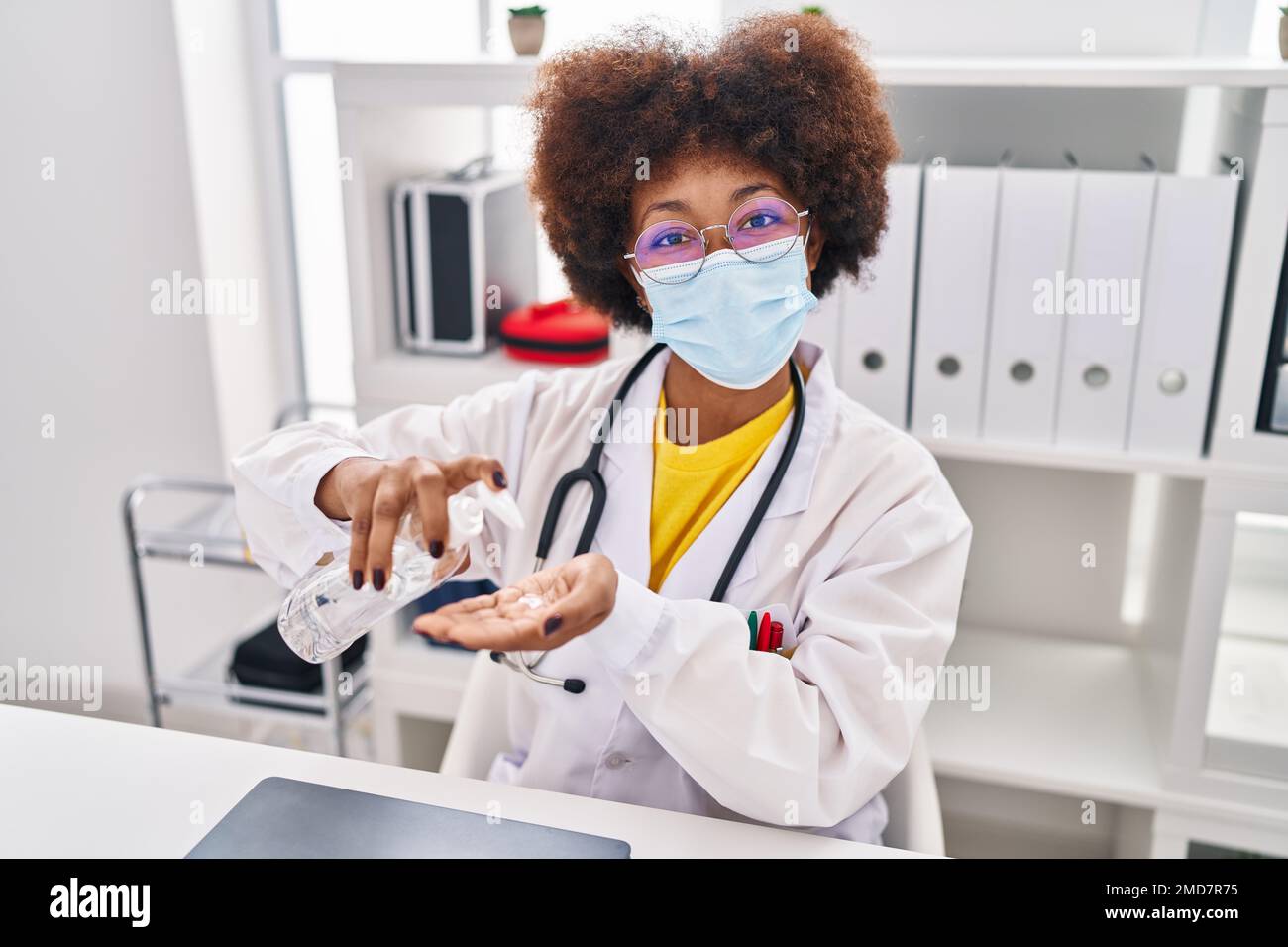 African american woman wearing doctor uniform and medical mask using ...