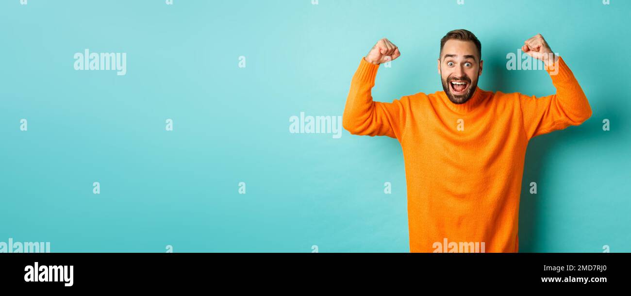 Handsome man celebrating victory, winning and looking happy, triumphing ...