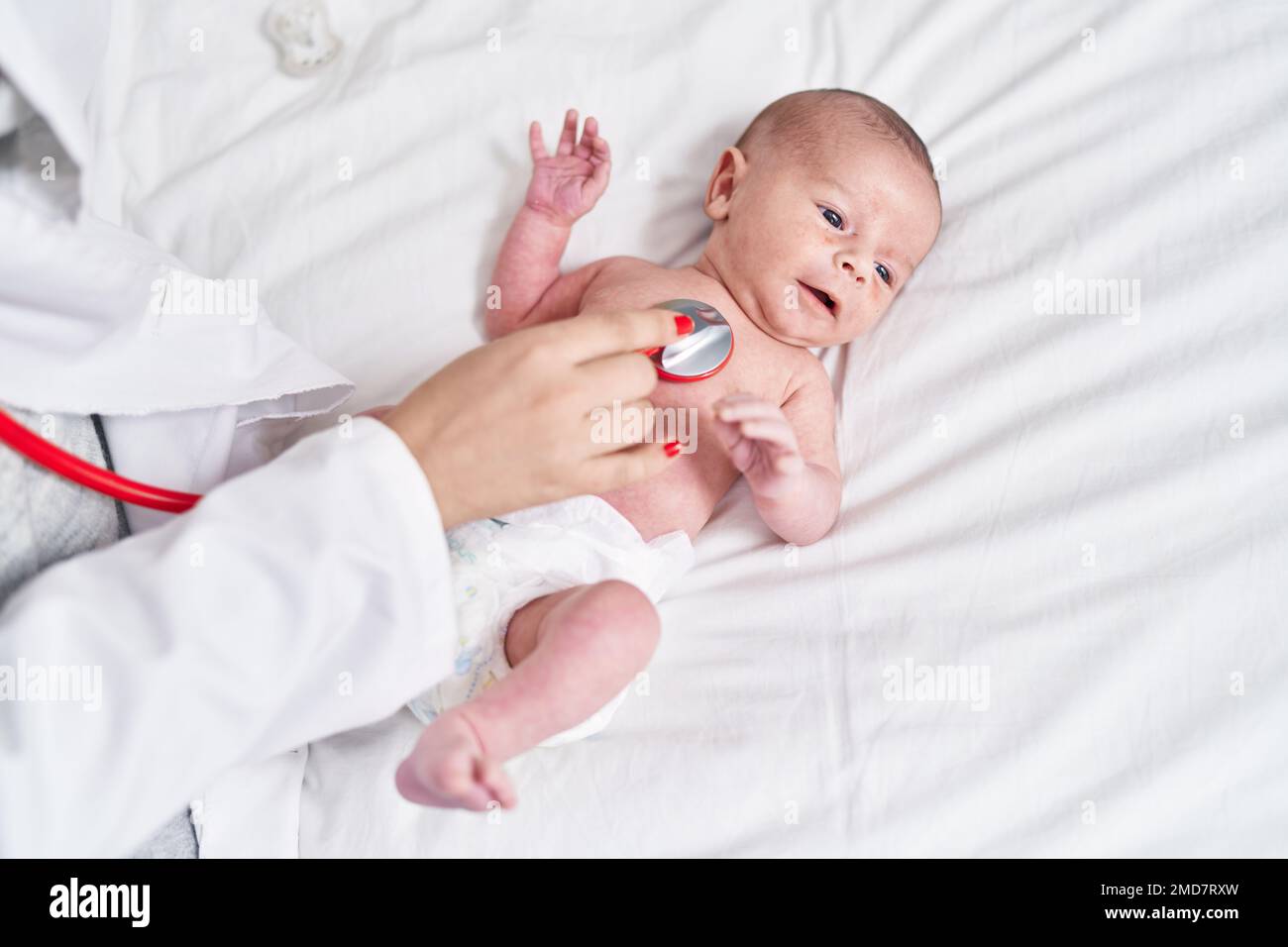 Adorable caucasian baby having heart examination with stethoscope at ...