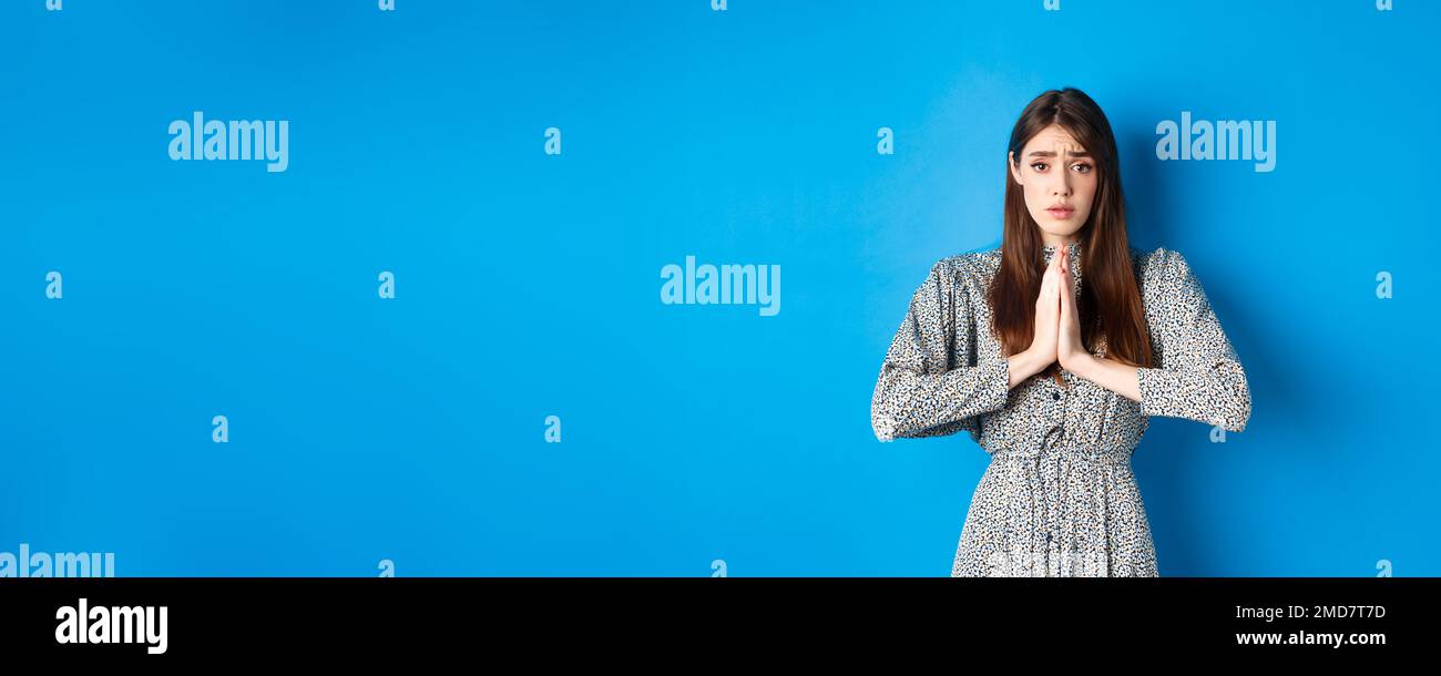 Sad girl asking for help, begging you with troubled face expression ...