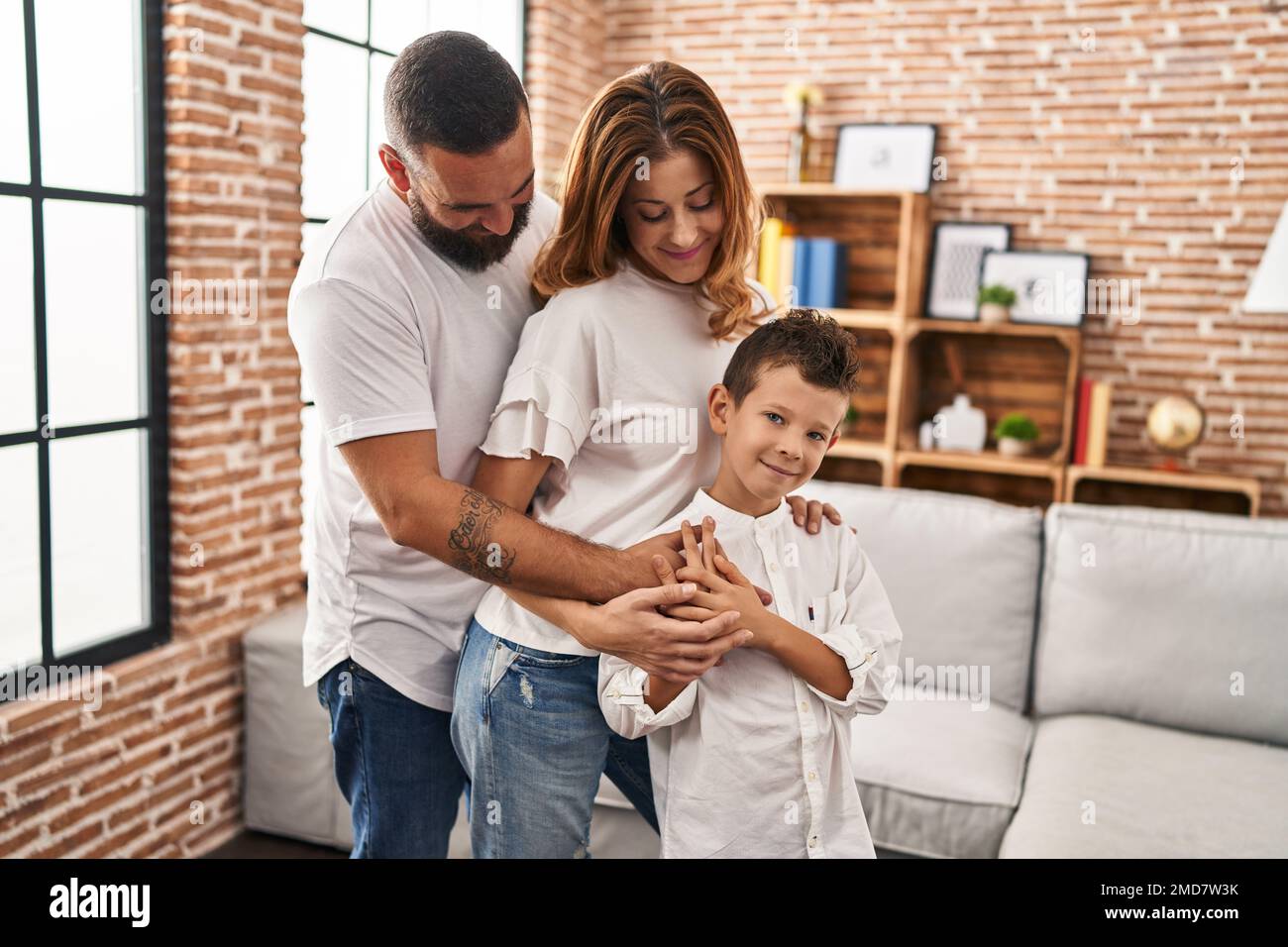 Family smiling confident hugging each other standing at home Stock ...