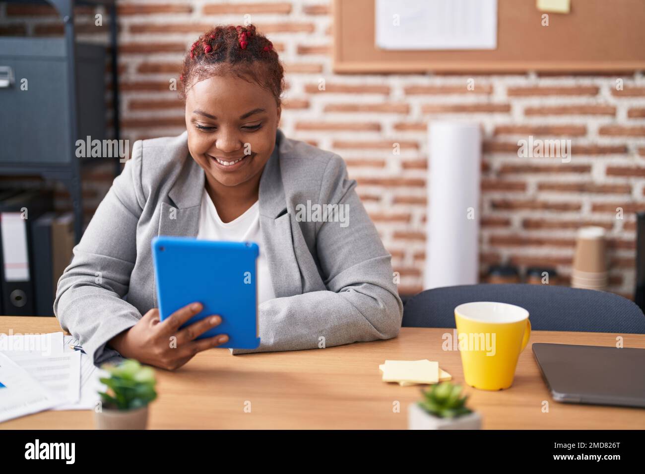 African american woman business worker using touchpad working at office ...