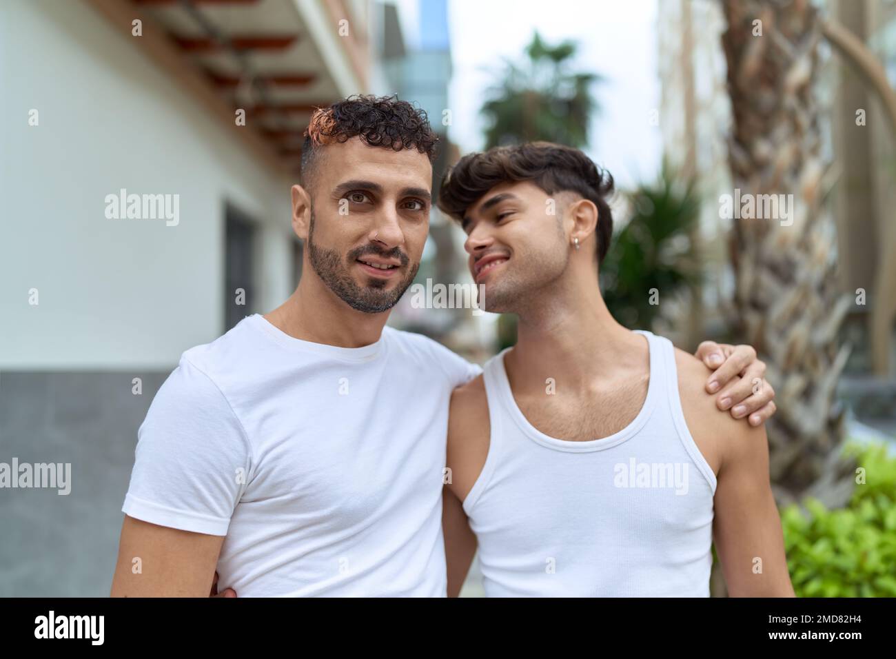 Two hispanic men couple smiling confident hugging each other at street ...