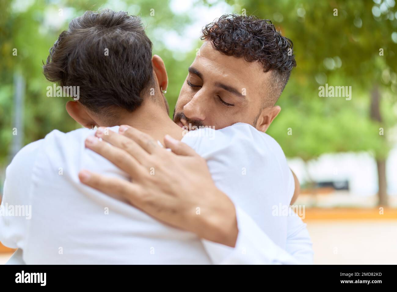 Two hispanic men couple smiling confident hugging each other at park ...
