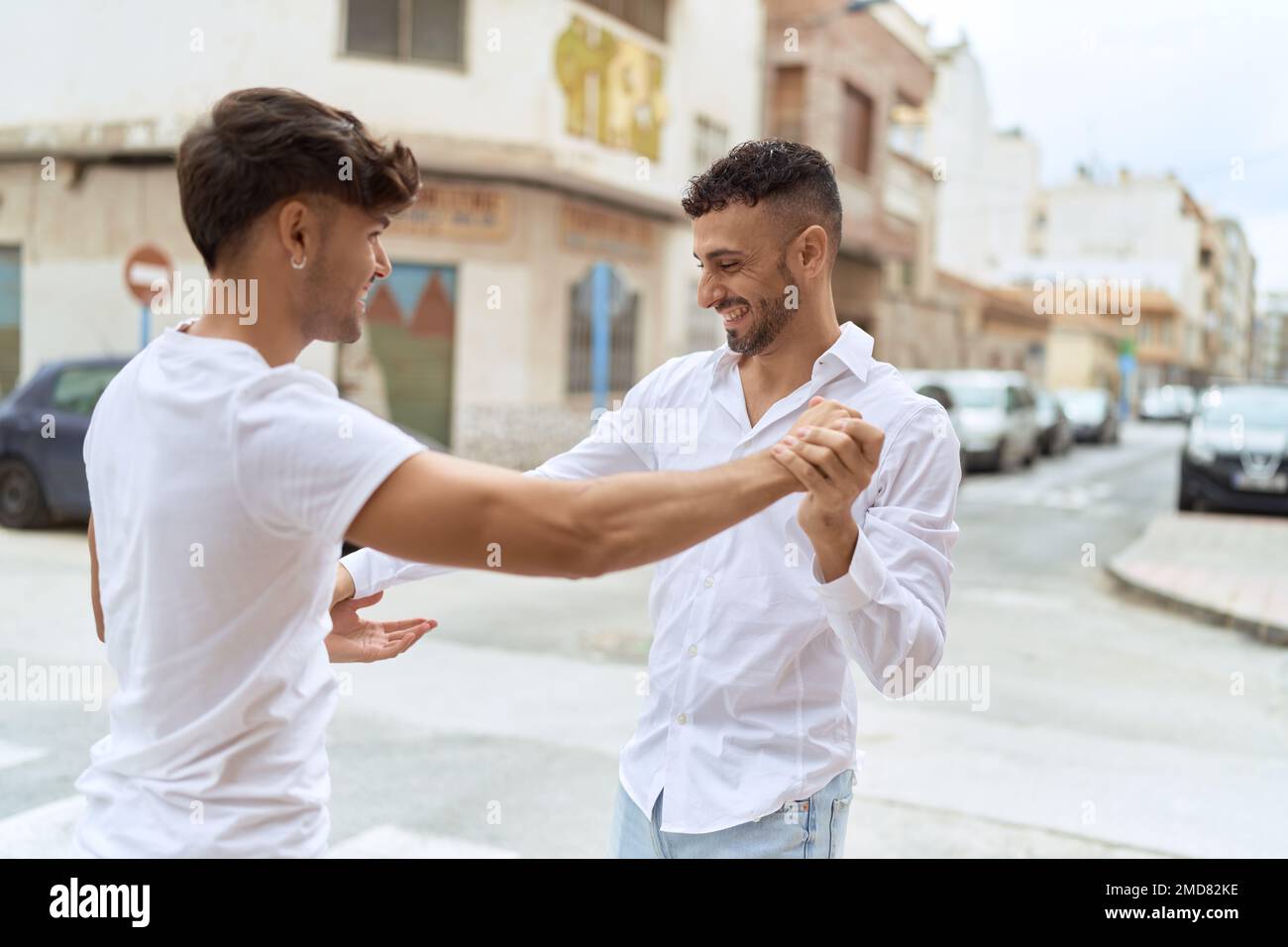 Two hispanic men couple smiling confident dancing at street Stock Photo ...