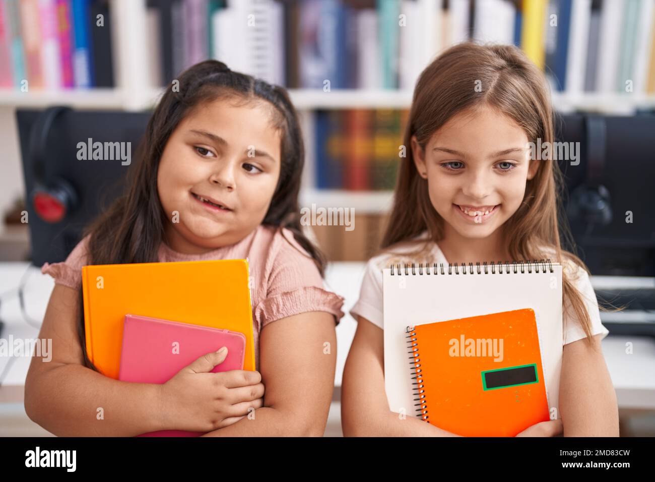 Two kids students smiling confident holding books at classroom Stock ...