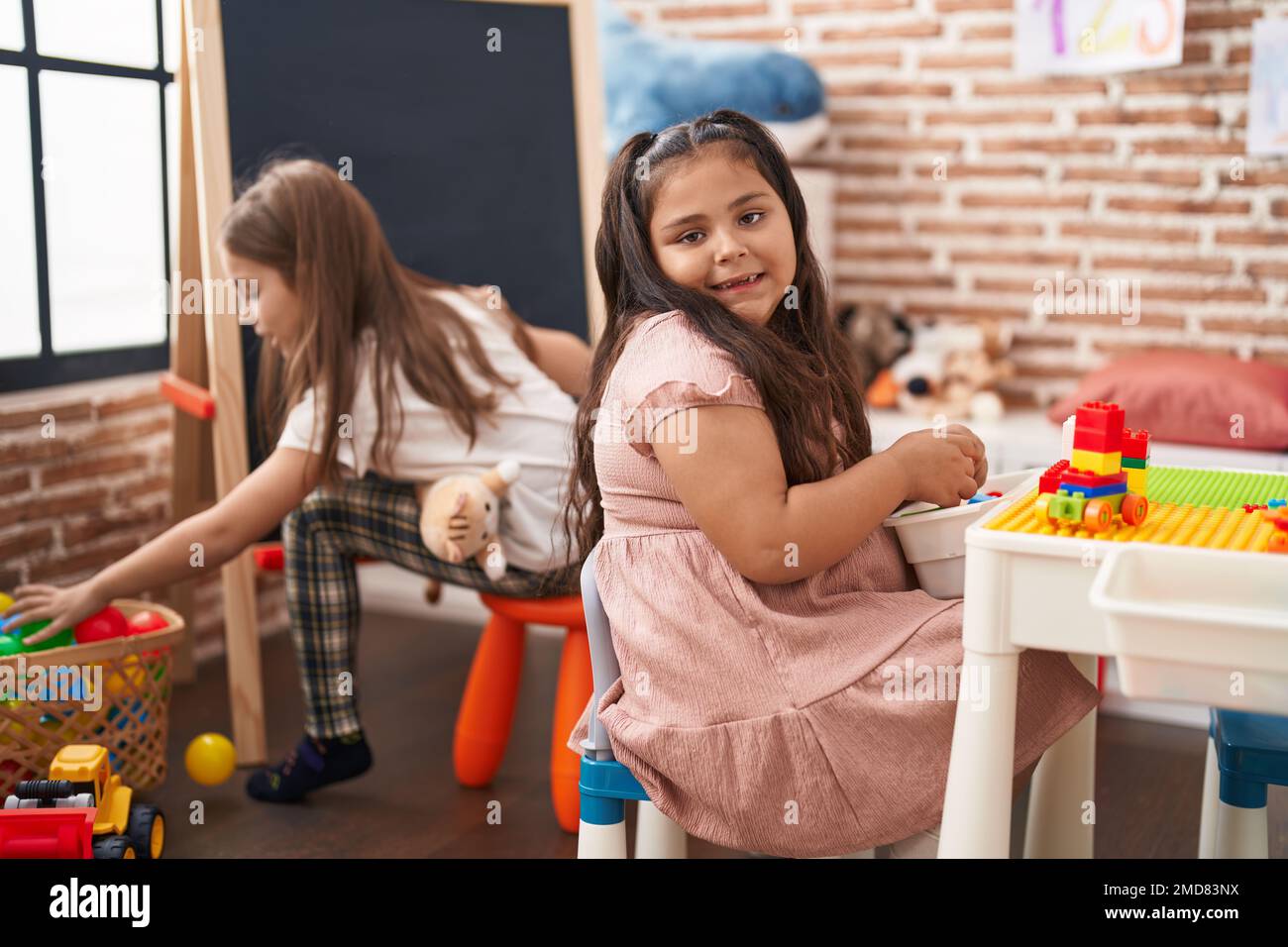 Two kids students using computer doing ok gesture with thumb up at ...