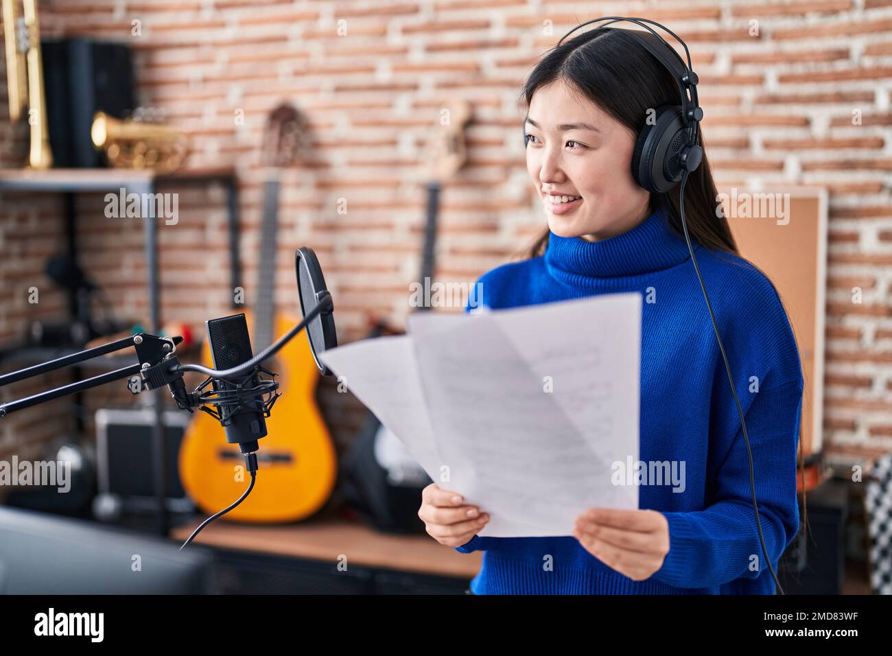 Chinese woman artist singing song at music studio Stock Photo - Alamy