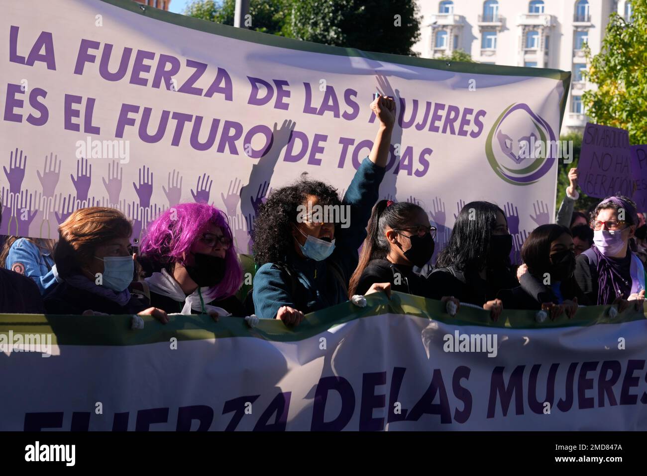 Women march with a banner reading ' The strength of women is the future ...
