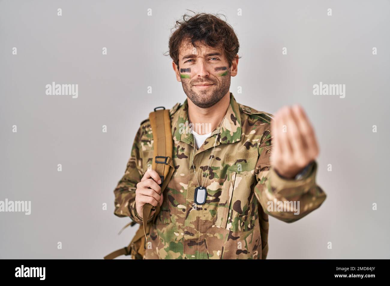 Hispanic young man wearing camouflage army uniform doing italian ...