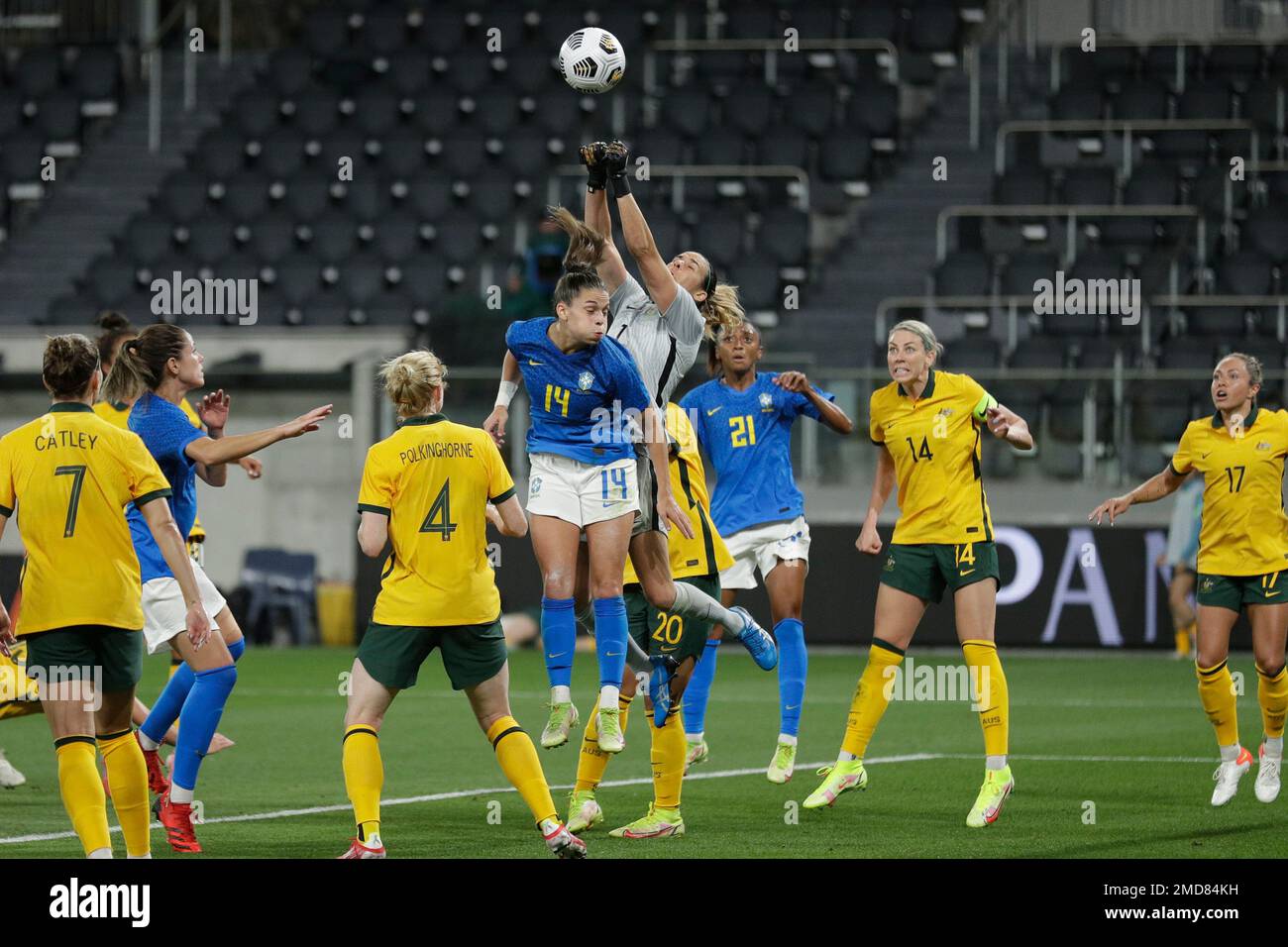 Australia's goalkeeper Lydia Williams, center, punches away the ball ...
