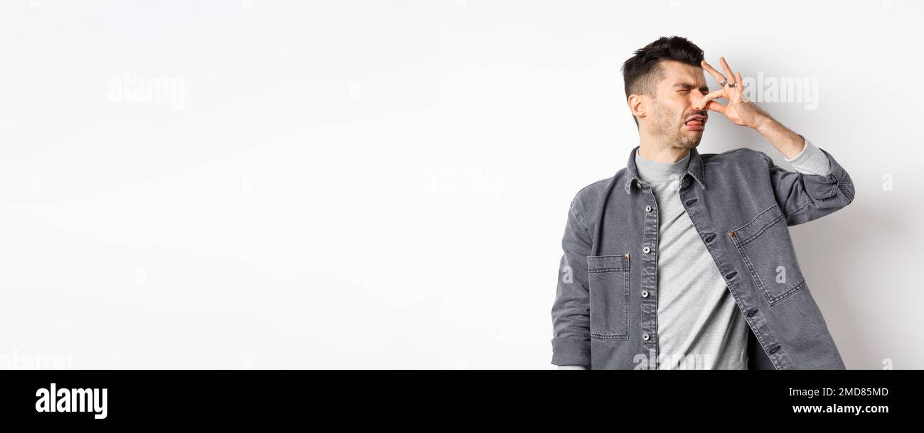 Disgusted man turn away and shut nose from bad smell, disgusting reek ...