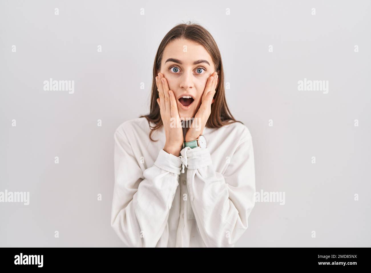 Young caucasian woman standing over isolated background afraid and ...