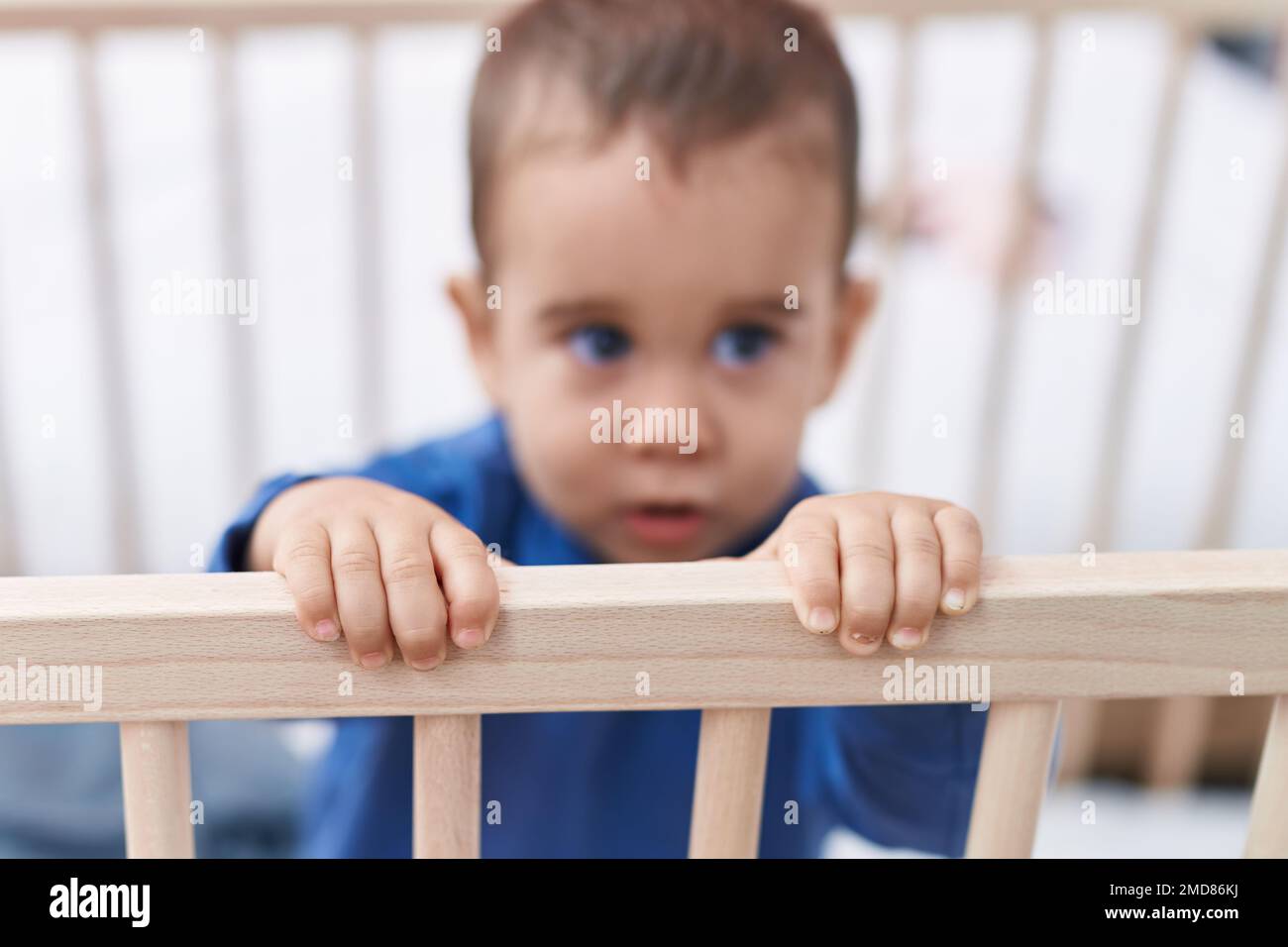 Adorable hispanic toddler standing on cradle at bedroom Stock Photo - Alamy