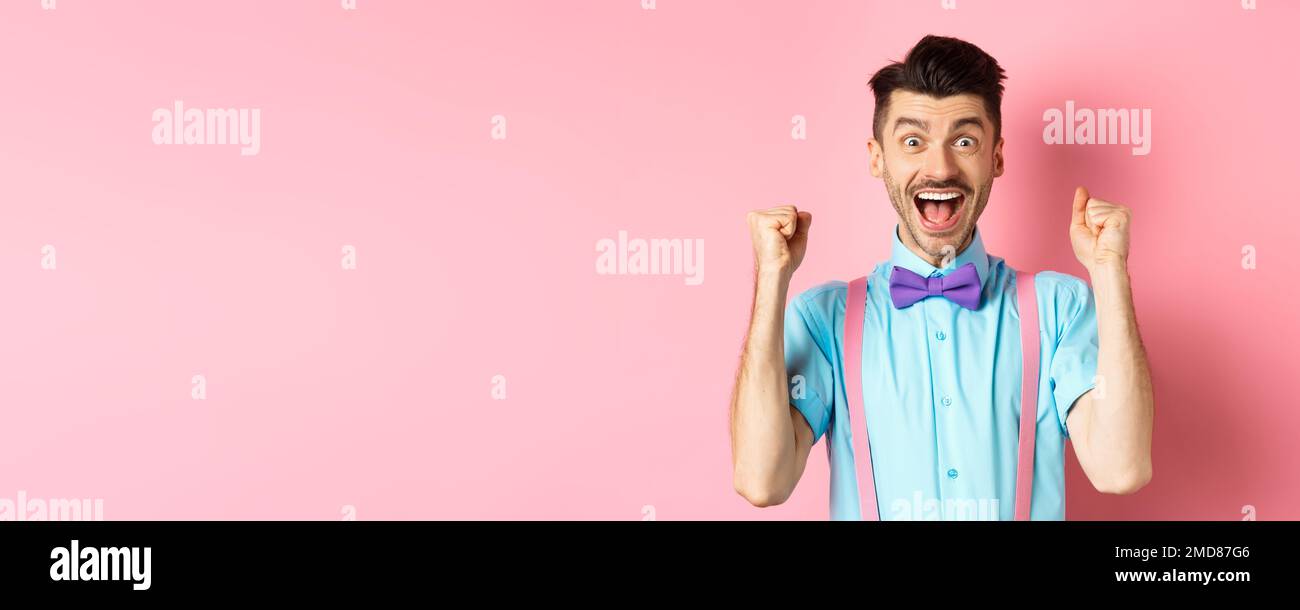 Happy guy winning prize, screaming with joy yes, shaking hands and ...