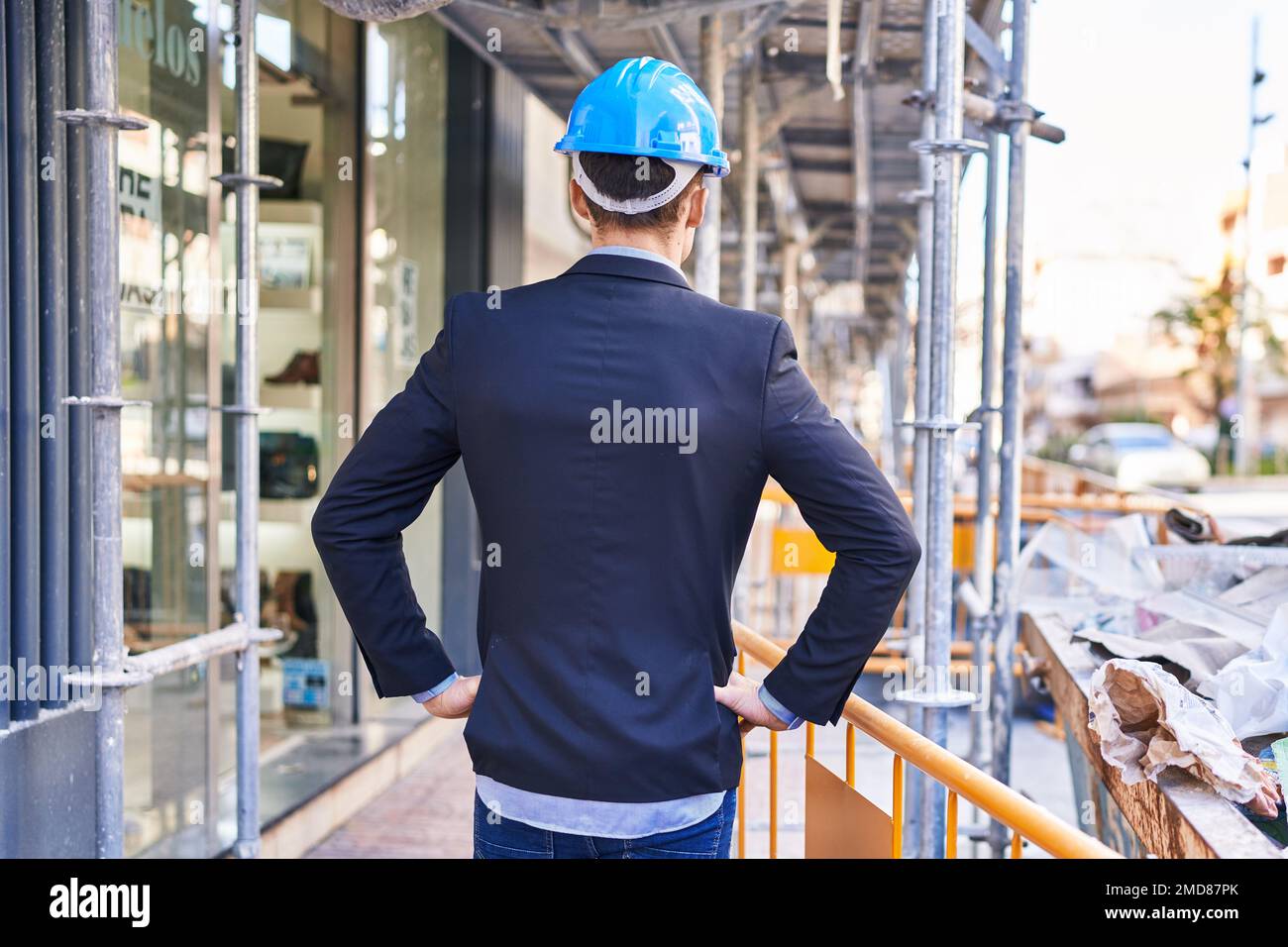 Young man architect standing on back view at street Stock Photo - Alamy