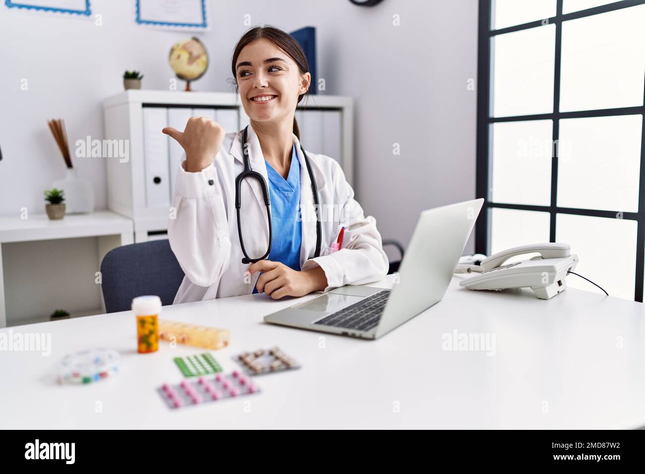 Young hispanic doctor woman wearing doctor uniform working at the ...