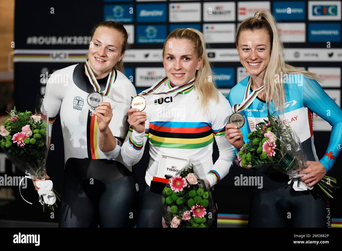Emma Hinze of Germany, center, shows her gold medal with Kelsey ...