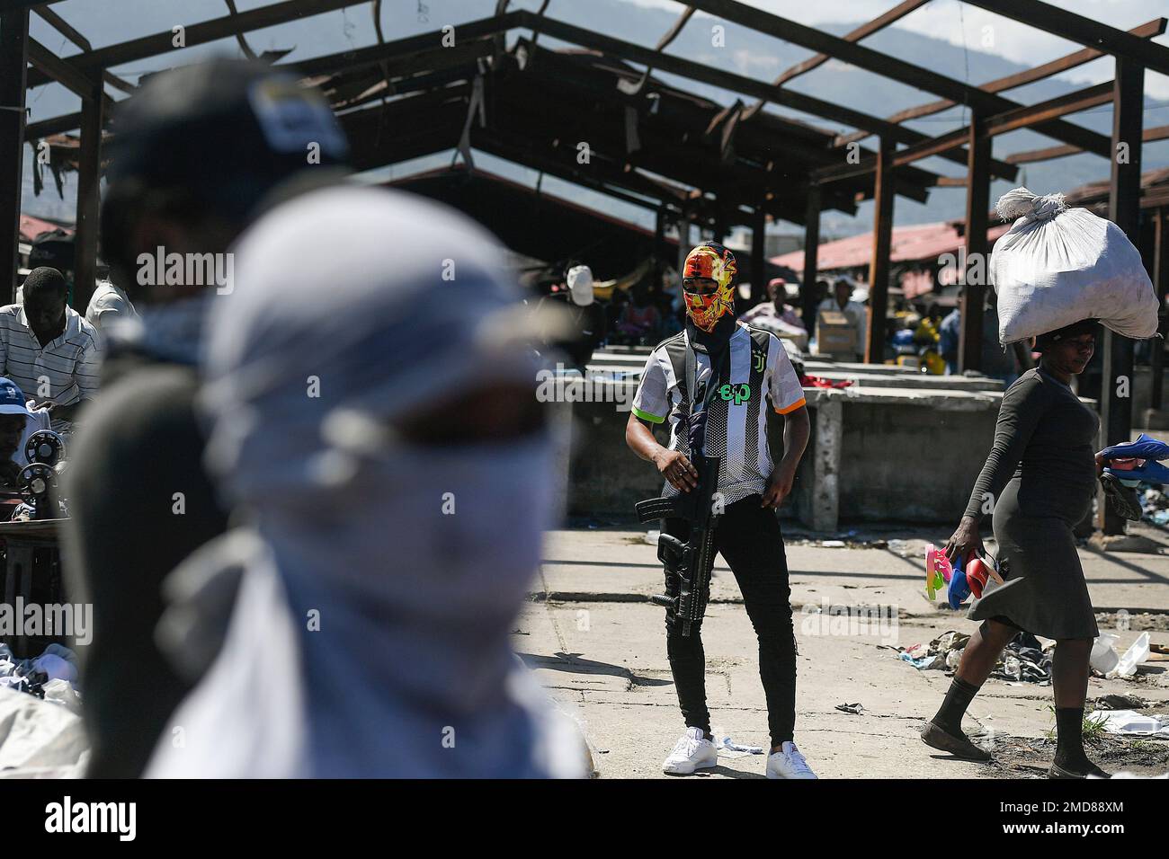An armed member of the "G9 and Family" gang stands guard on the ...