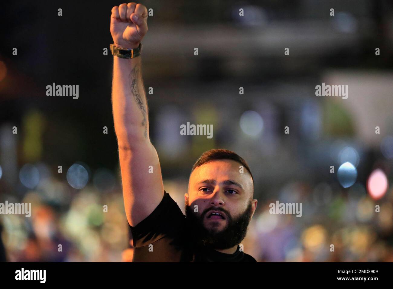 A Hezbollah supporter rises his hand as he shouts slogans pro-Hezbollah ...
