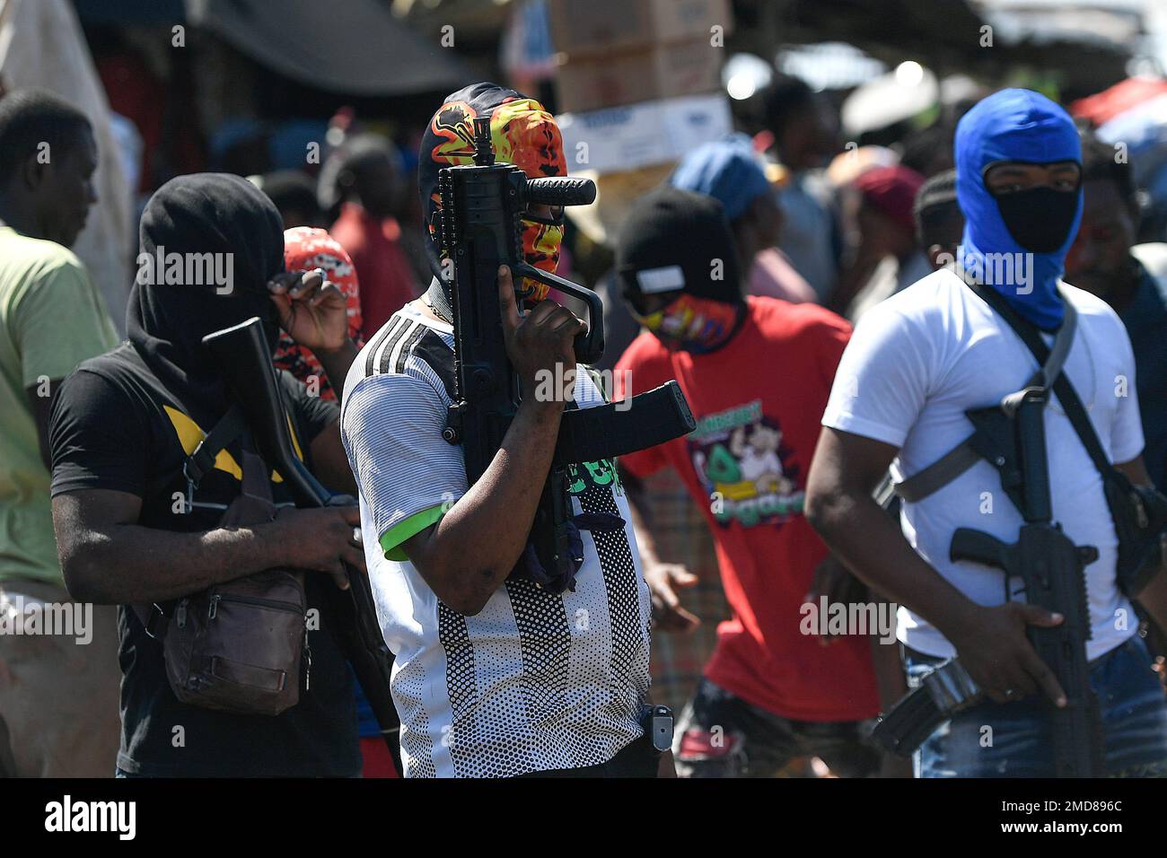 Members of the "G9 and Family" gang hold weapons as the group marches ...