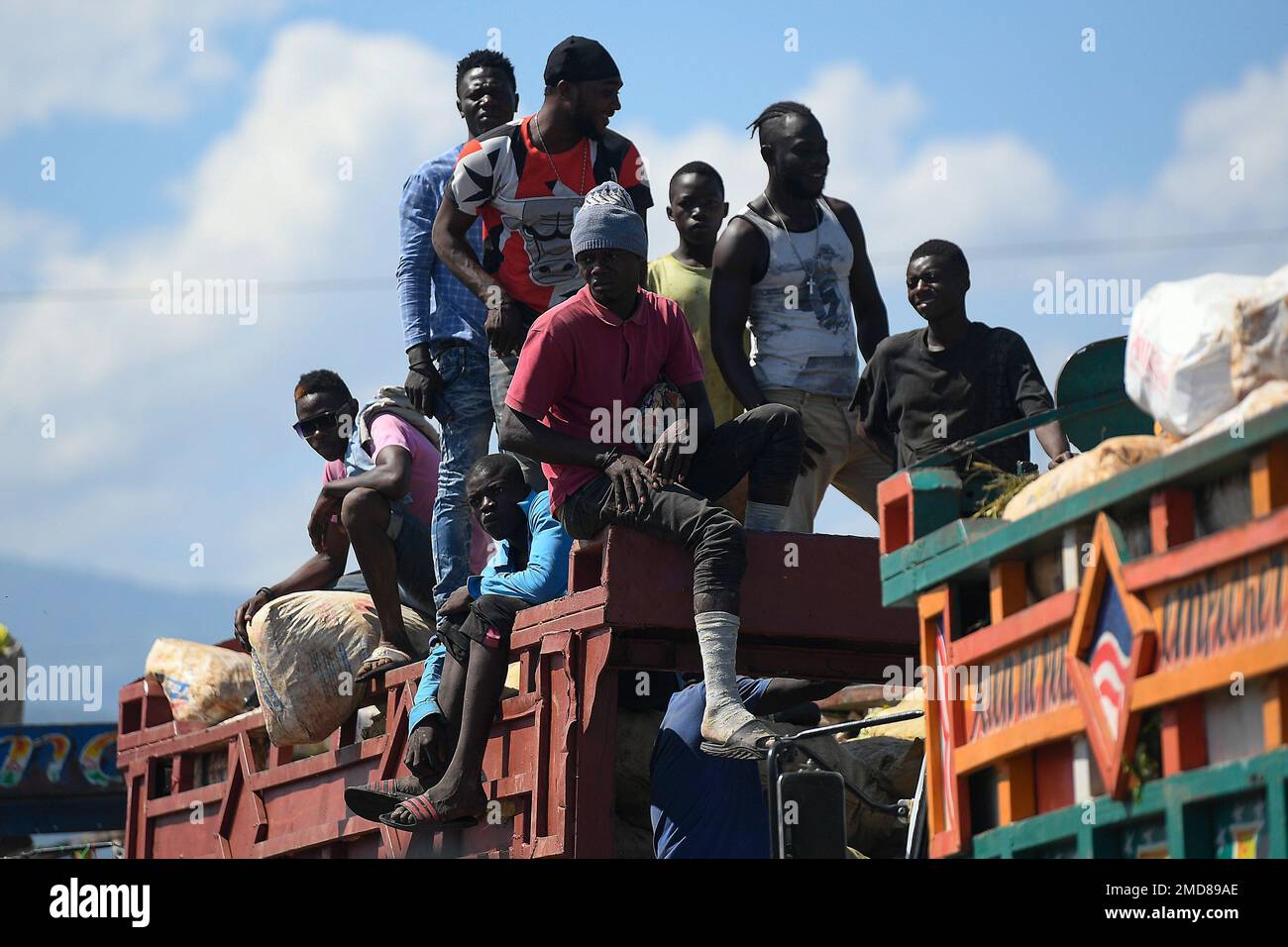 Market workers watch members of the "G9 and Family" gang march in La ...