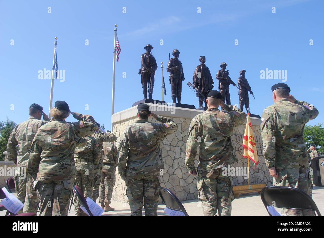 Members of the official party salute during the national anthem July 14 ...