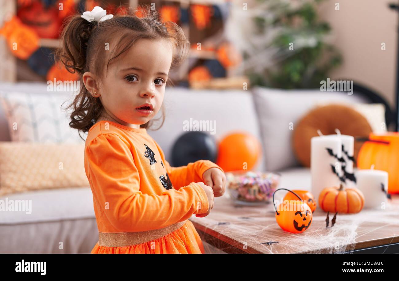 Adorable hispanic toddler having halloween party standing at home Stock ...