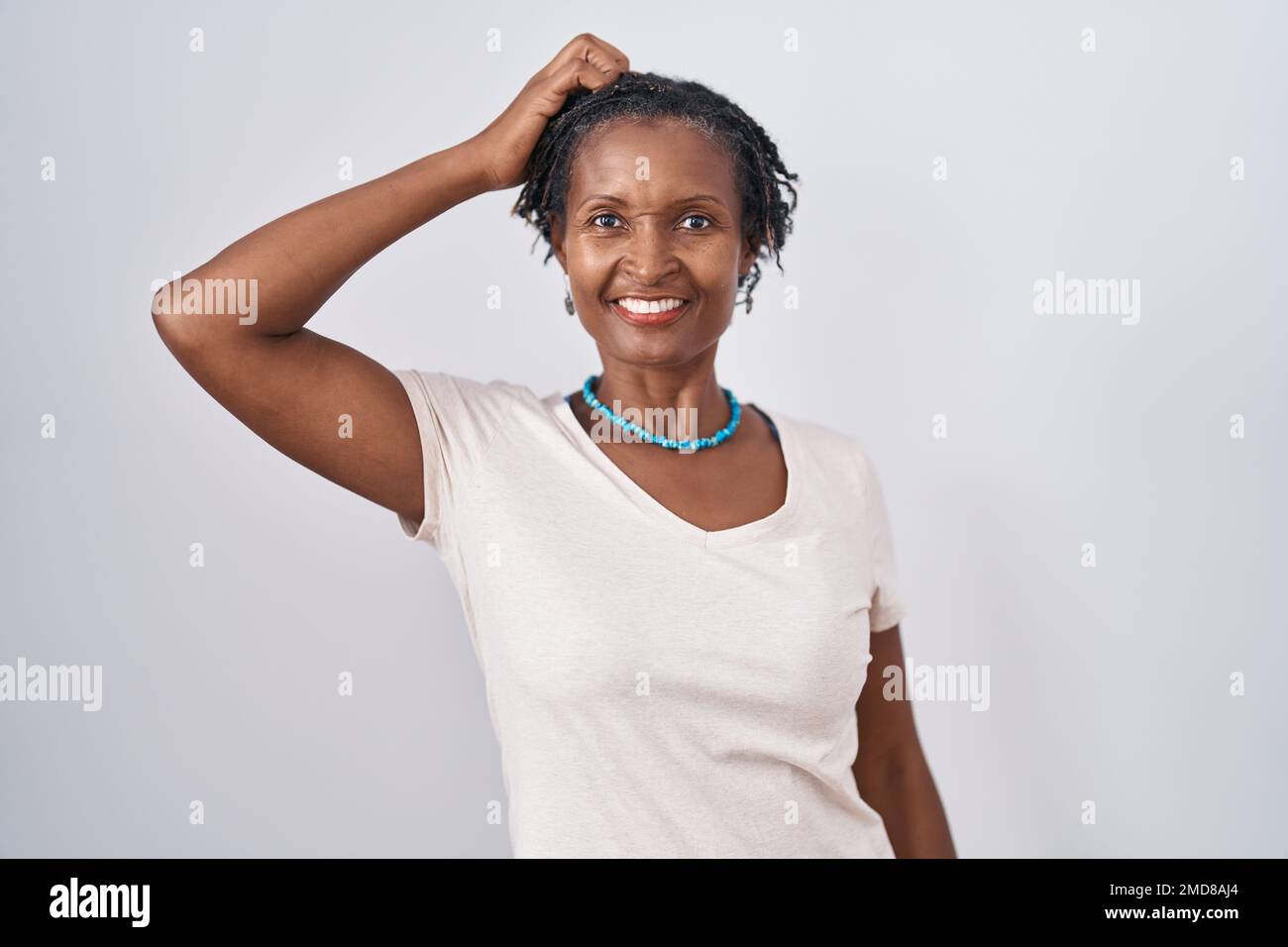 African woman with dreadlocks standing over white background confuse ...
