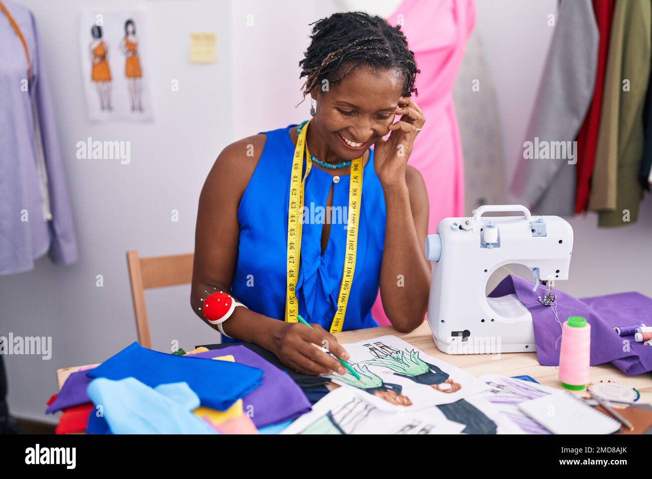 Middle age african american woman tailor smiling confident drawing ...