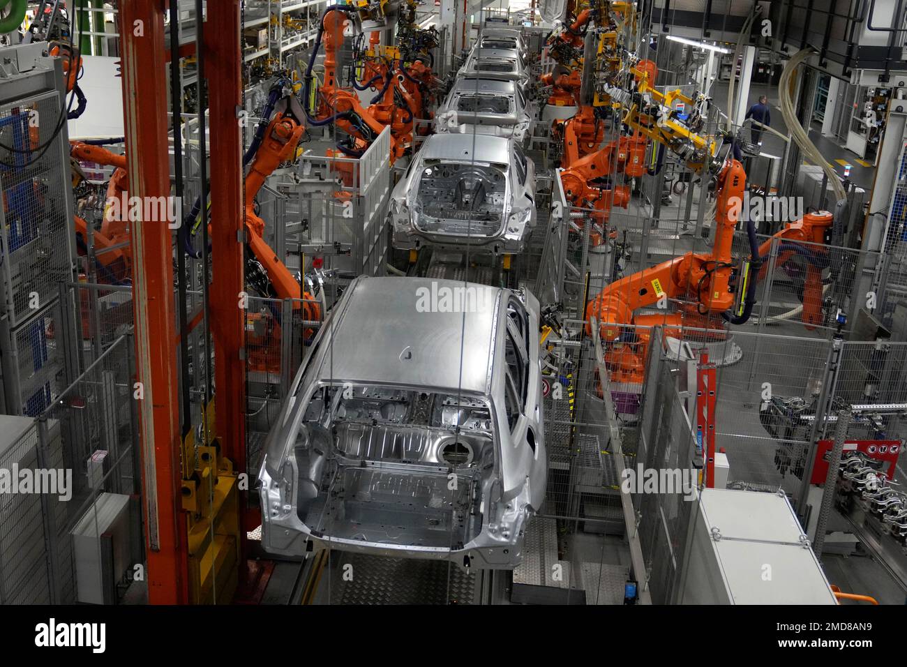 Robots work on cars of German car manufacturer BMW at an assembly line ...