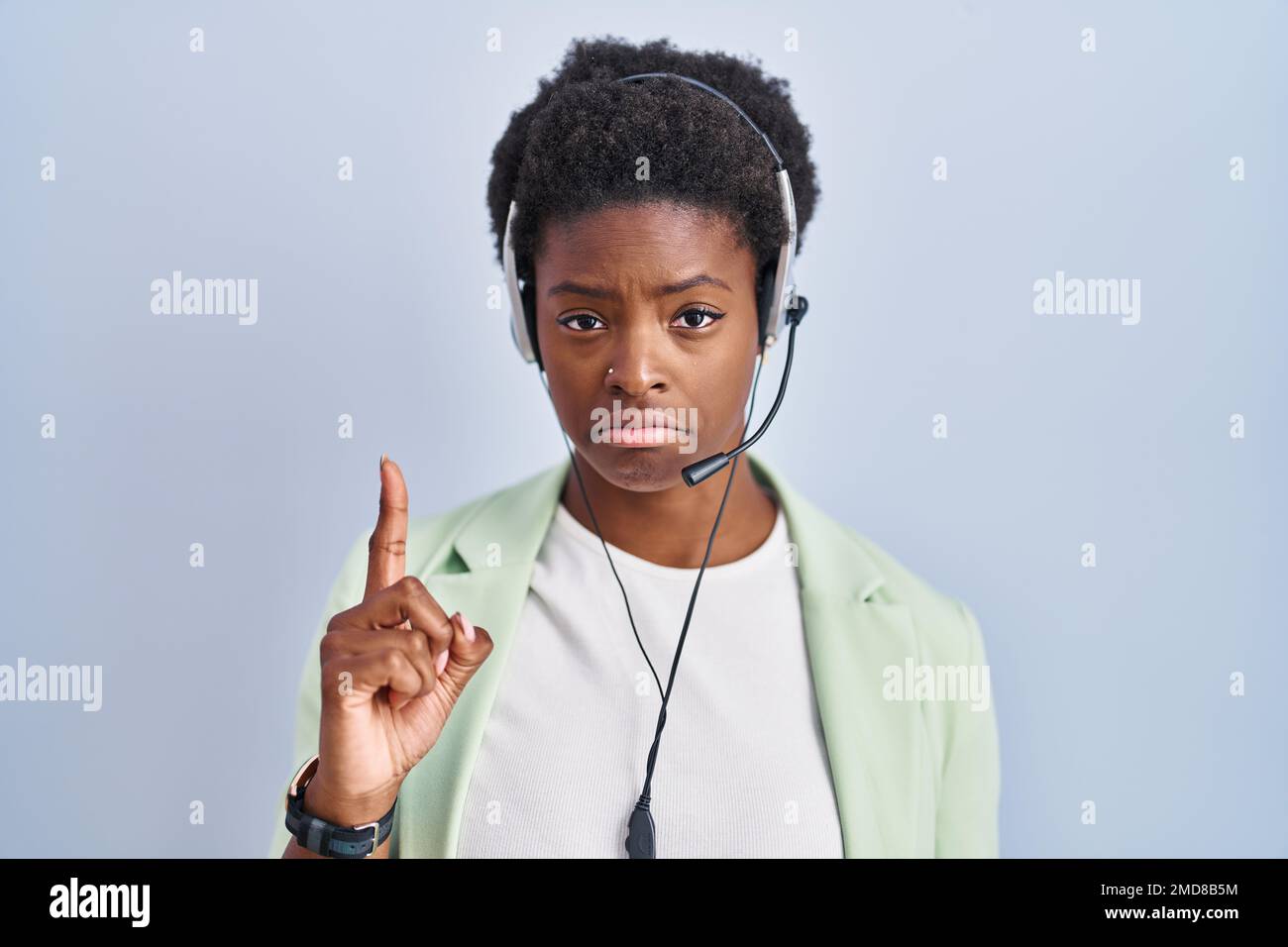 African american woman wearing call center agent headset pointing up ...