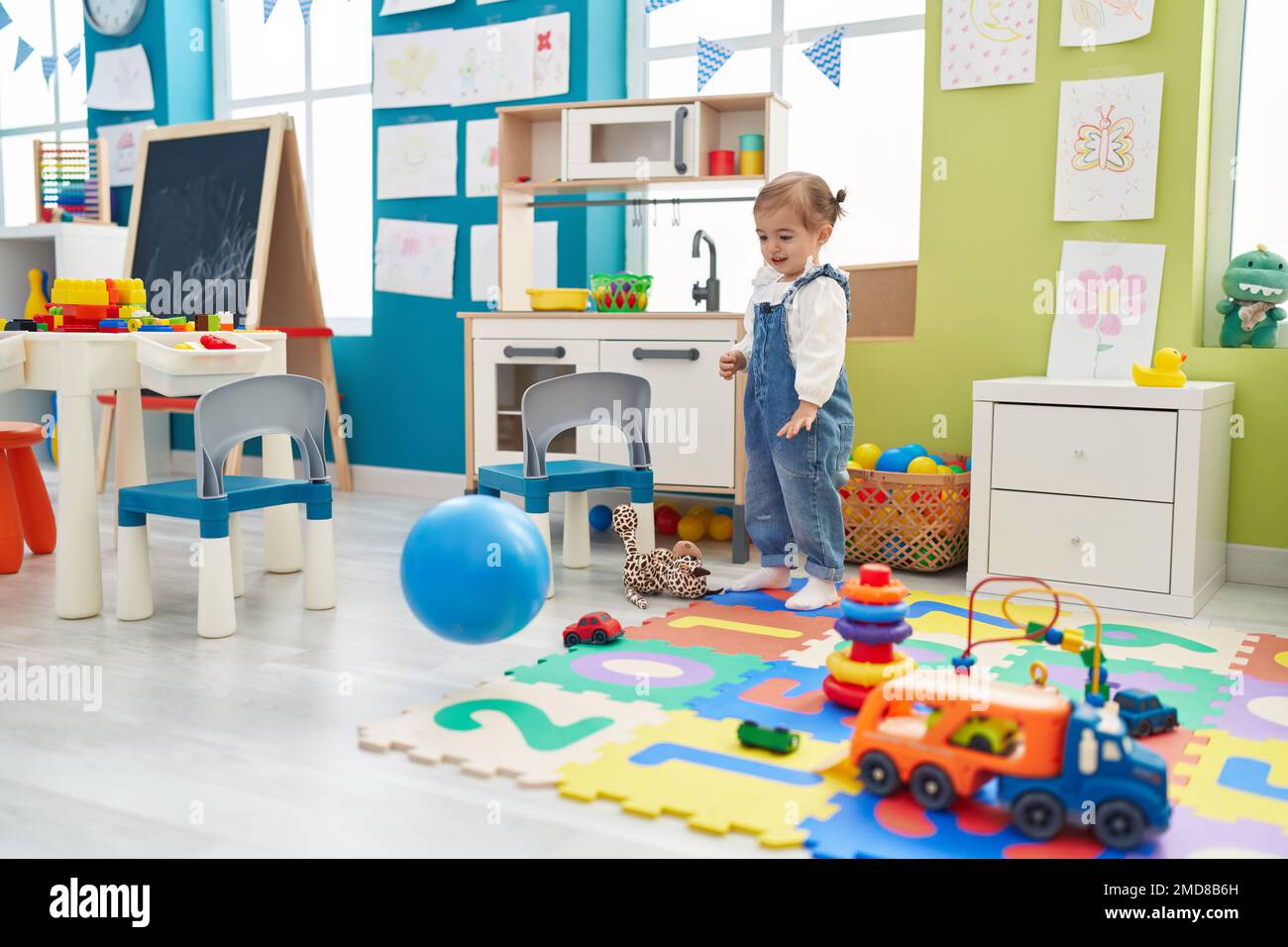 Adorable blonde toddler smiling confident standing at kindergarten Stock Photo - Alamy