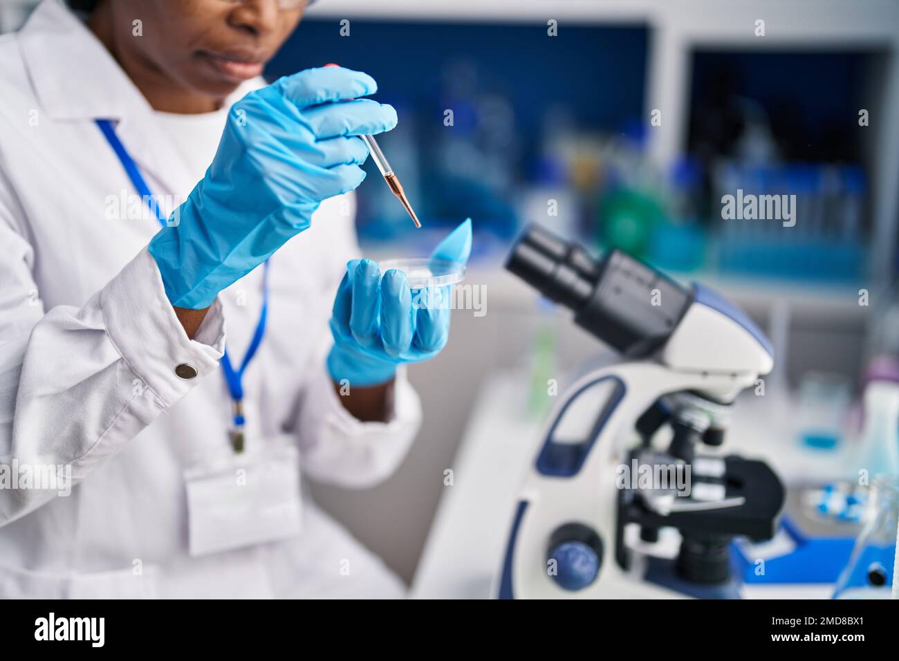 African american woman wearing scientist uniform working laboratory ...
