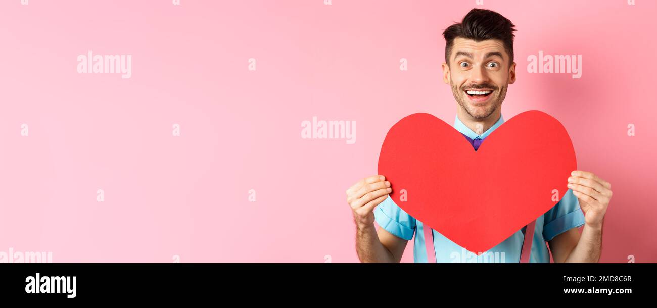 Valentines day concept. Romantic man falling in love, showing big red ...