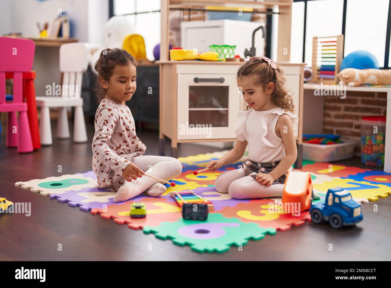 Two kids playing xylophone hi-res stock photography and images - Alamy