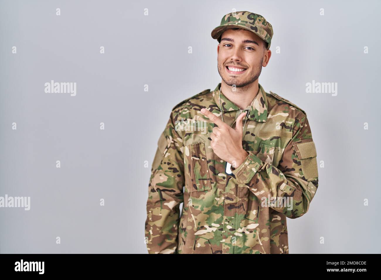 Young hispanic man wearing camouflage army uniform cheerful with a ...