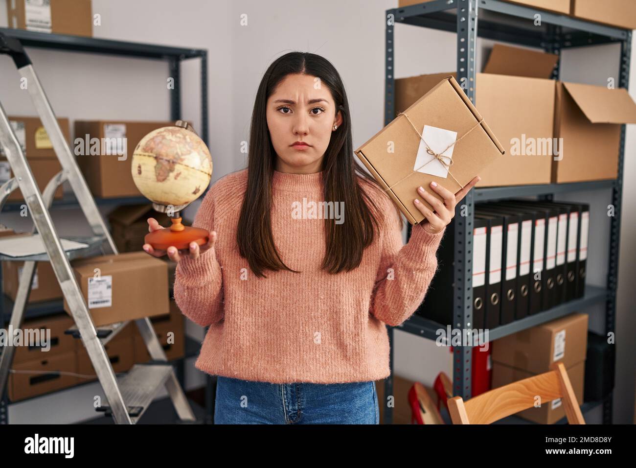 Young latin woman working at small business ecommerce doing world ...