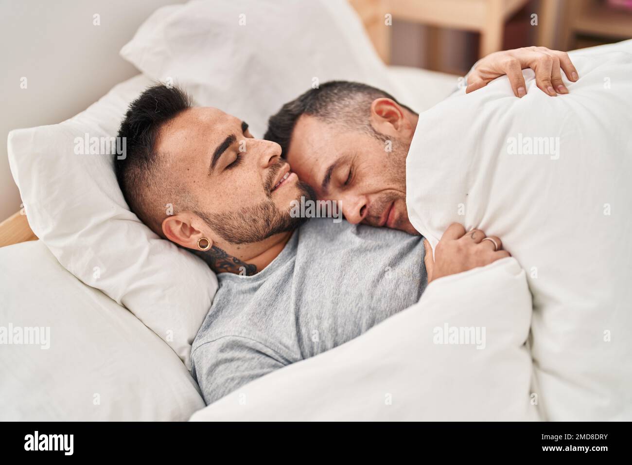 Two men couple lying on bed sleeping at bedroom Stock Photo - Alamy