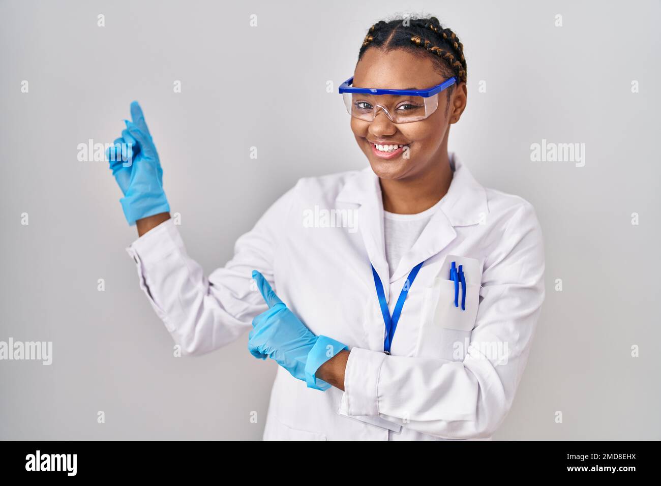 African american woman with braids wearing scientist robe smiling and ...