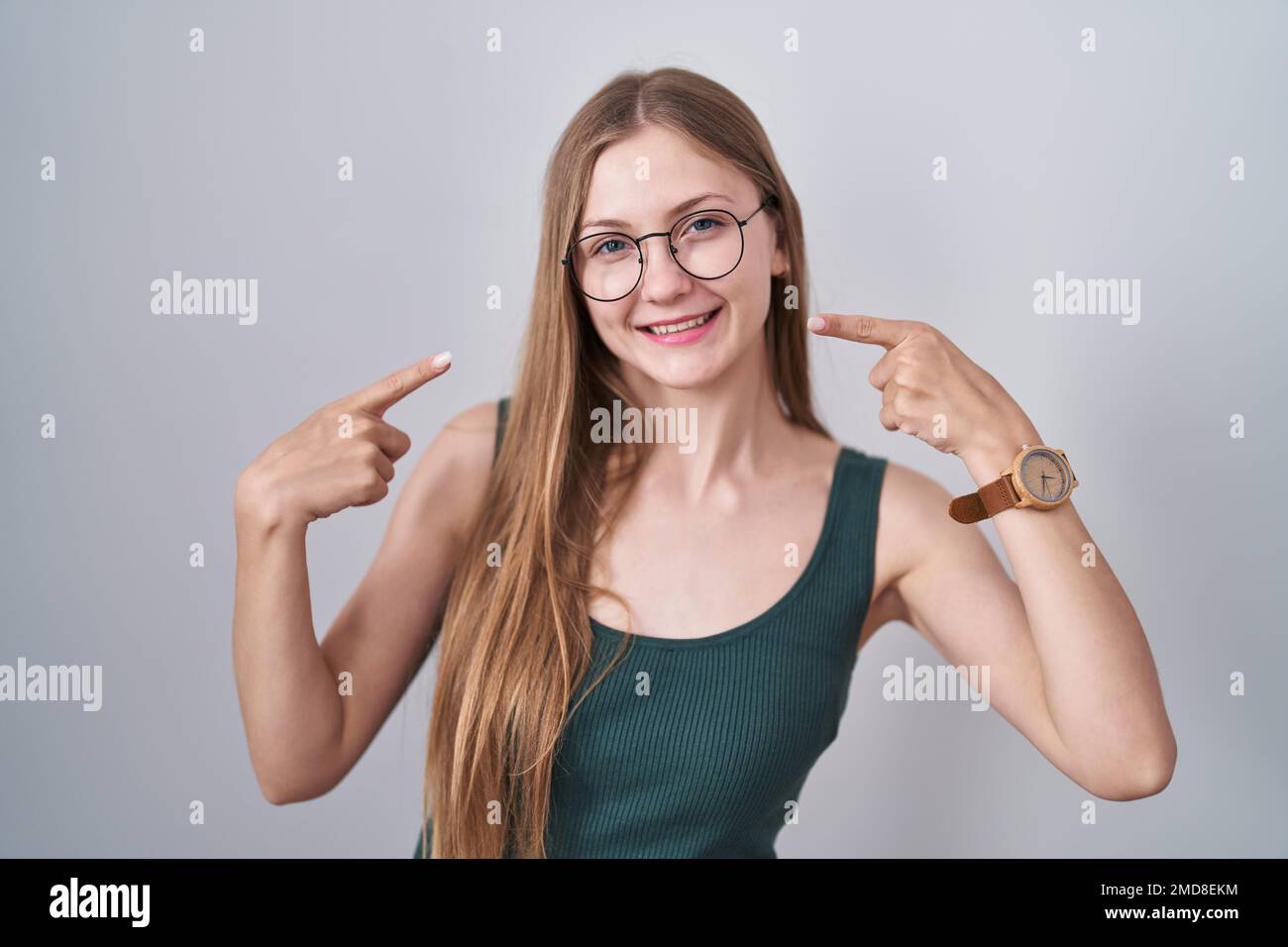 Young caucasian woman standing over white background smiling cheerful ...