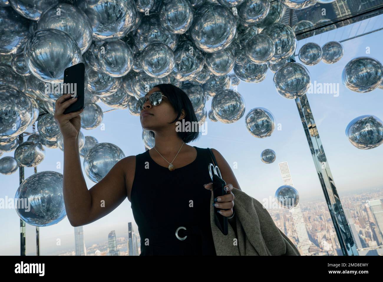 An invitee browses a roomful of helium-filled balloons at the grand ...