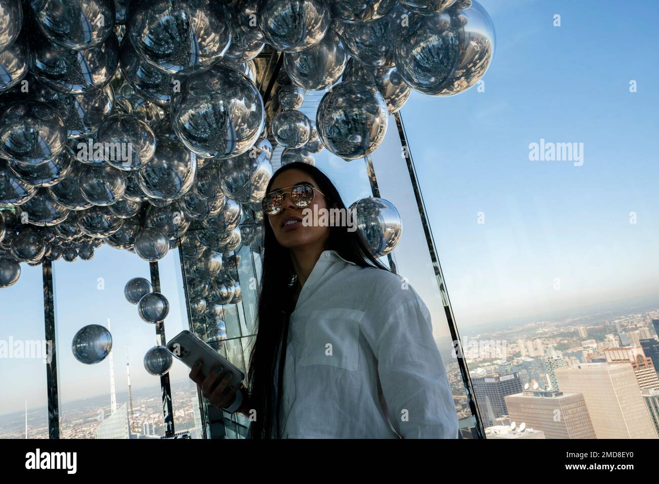 An invitee browses a roomful of helium-filled balloons at the grand ...