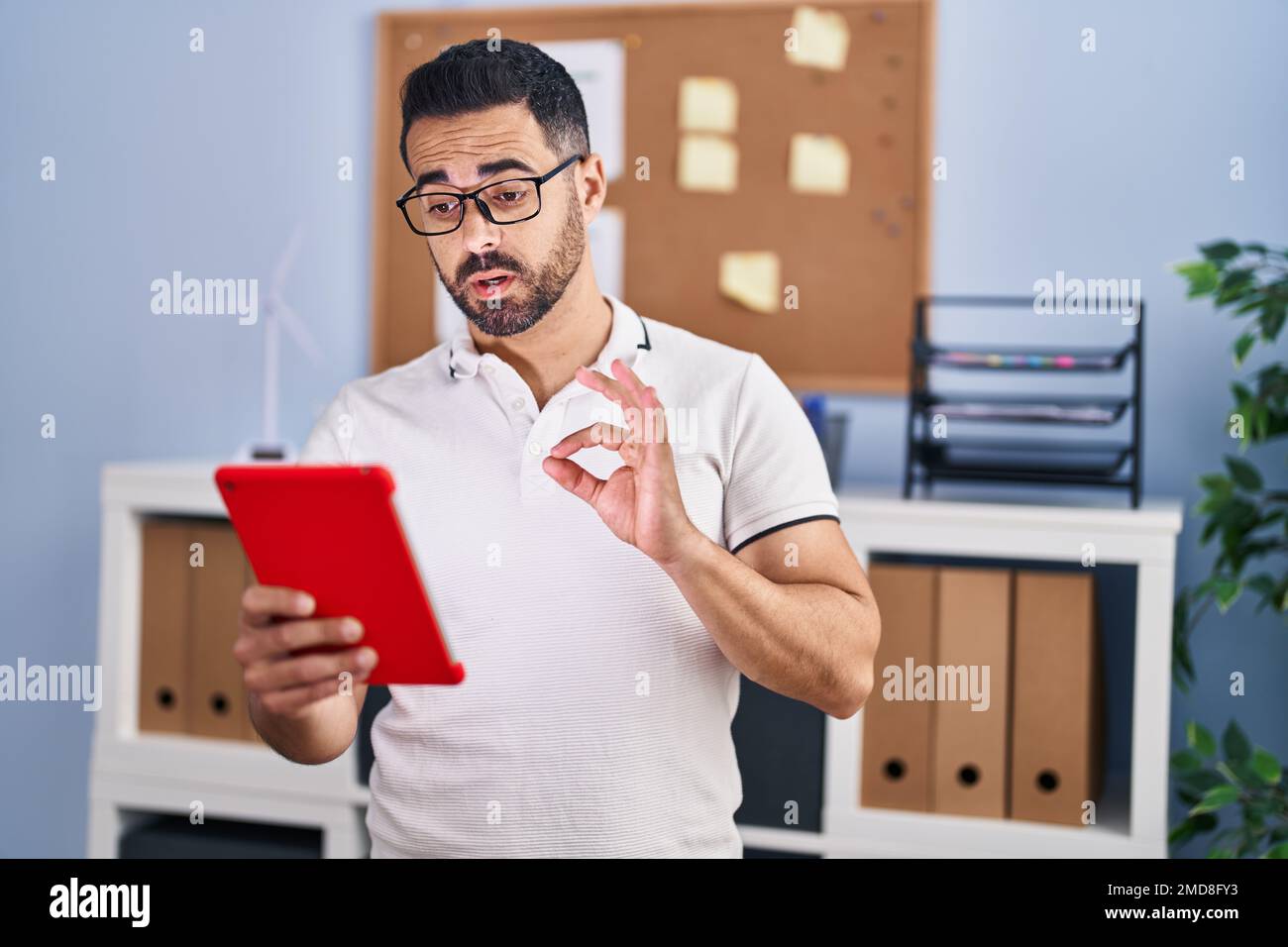 Young hispanic man business worker having video call at office Stock ...