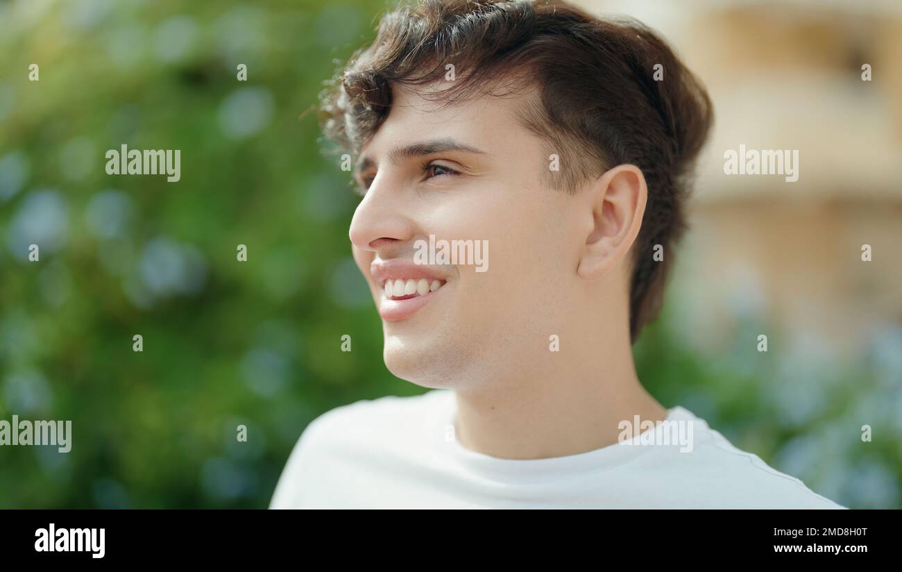 Non binary man smiling confident looking to the side at park Stock ...