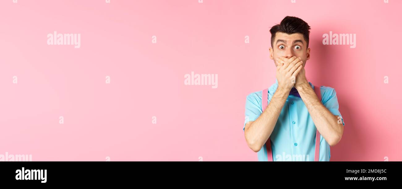Shocked and speechless guy shut his mouth, cover lips with hands and ...