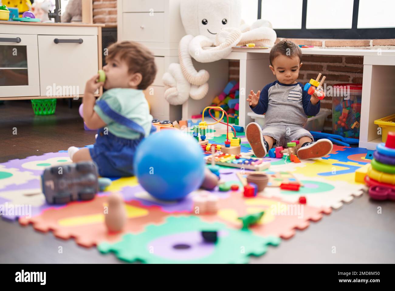 Two kids playing with toys at kindergarten Stock Photo - Alamy