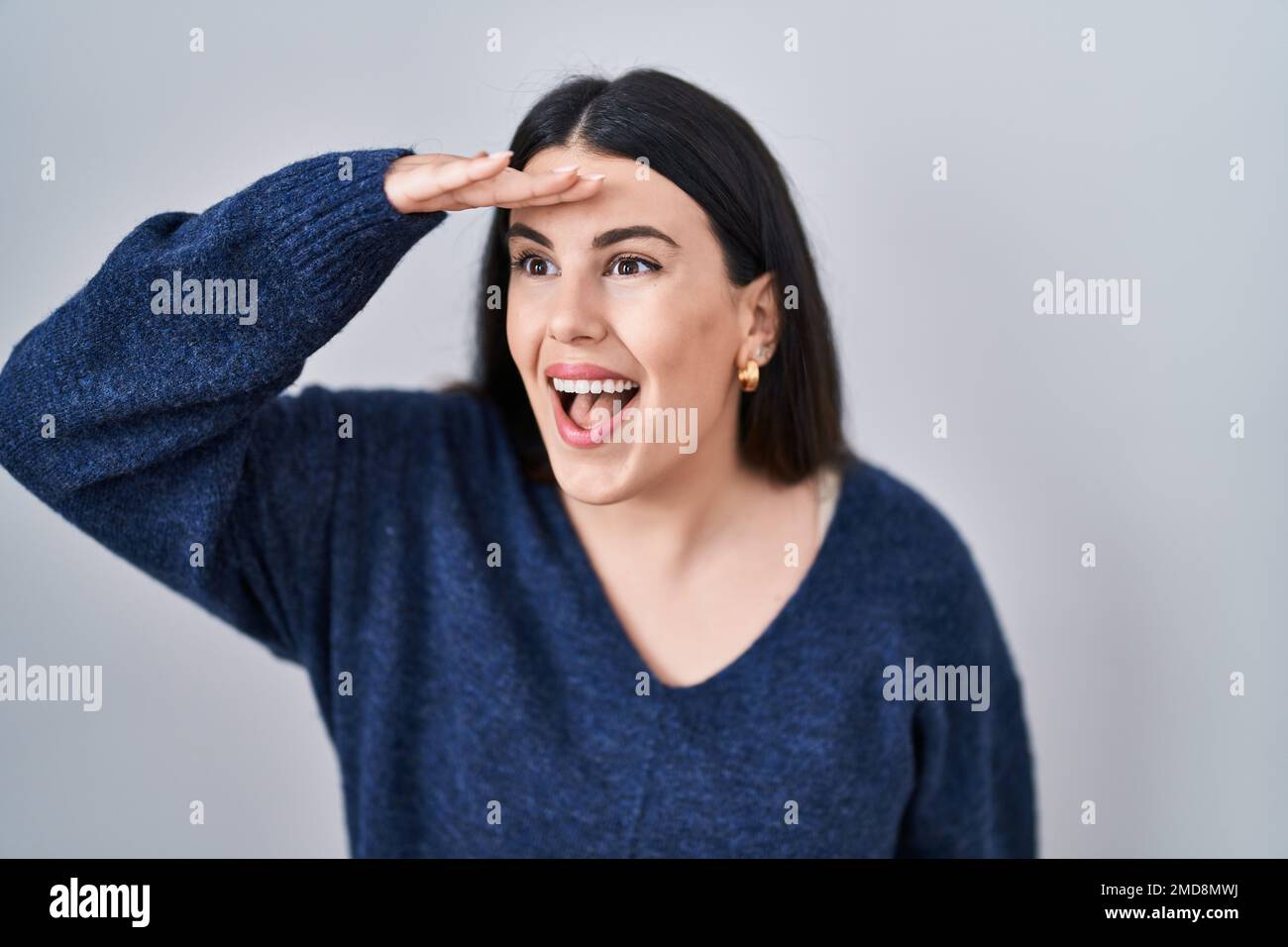 Young brunette woman standing over isolated background very happy and ...