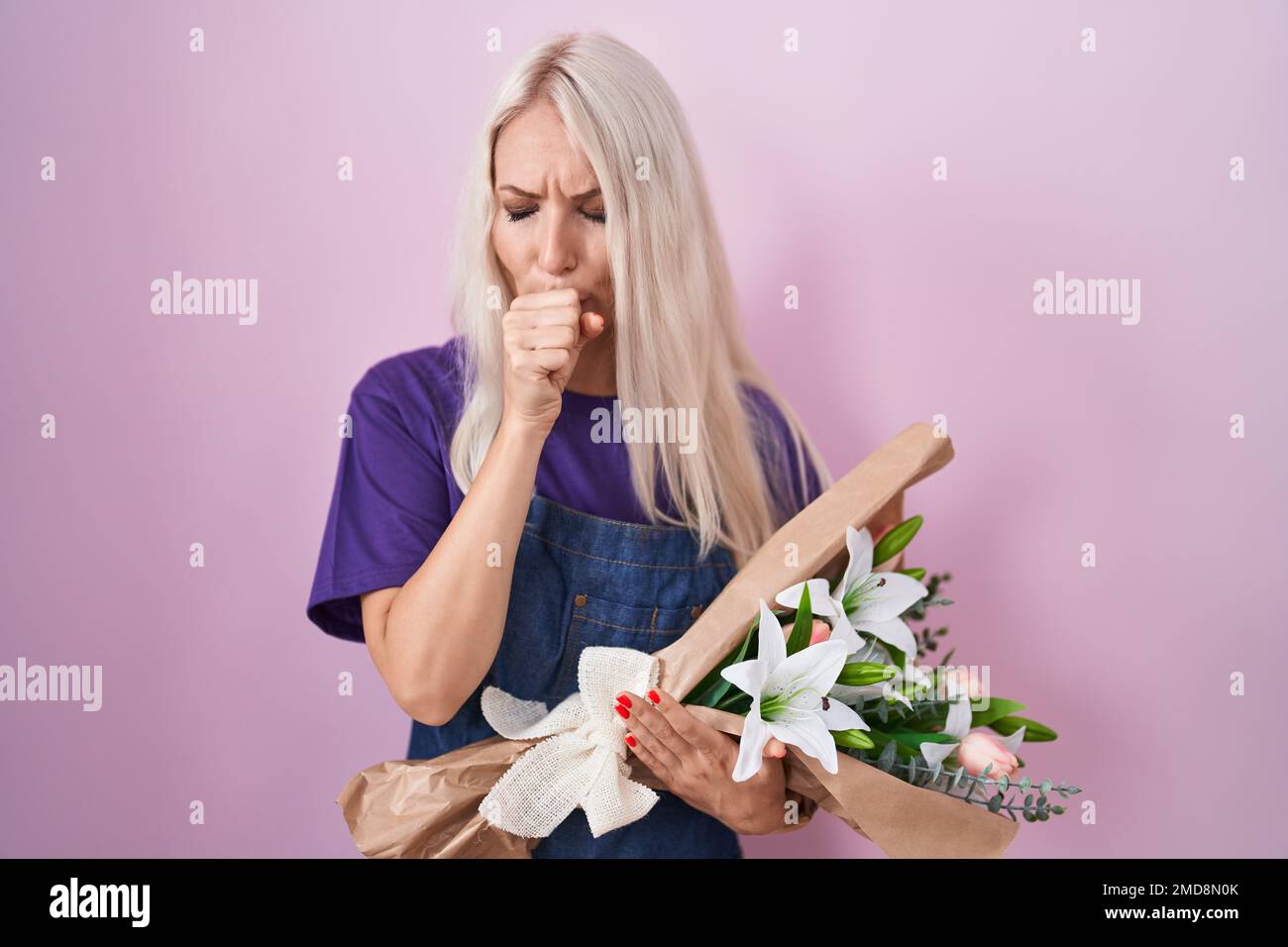 Caucasian woman holding bouquet of white flowers feeling unwell and ...