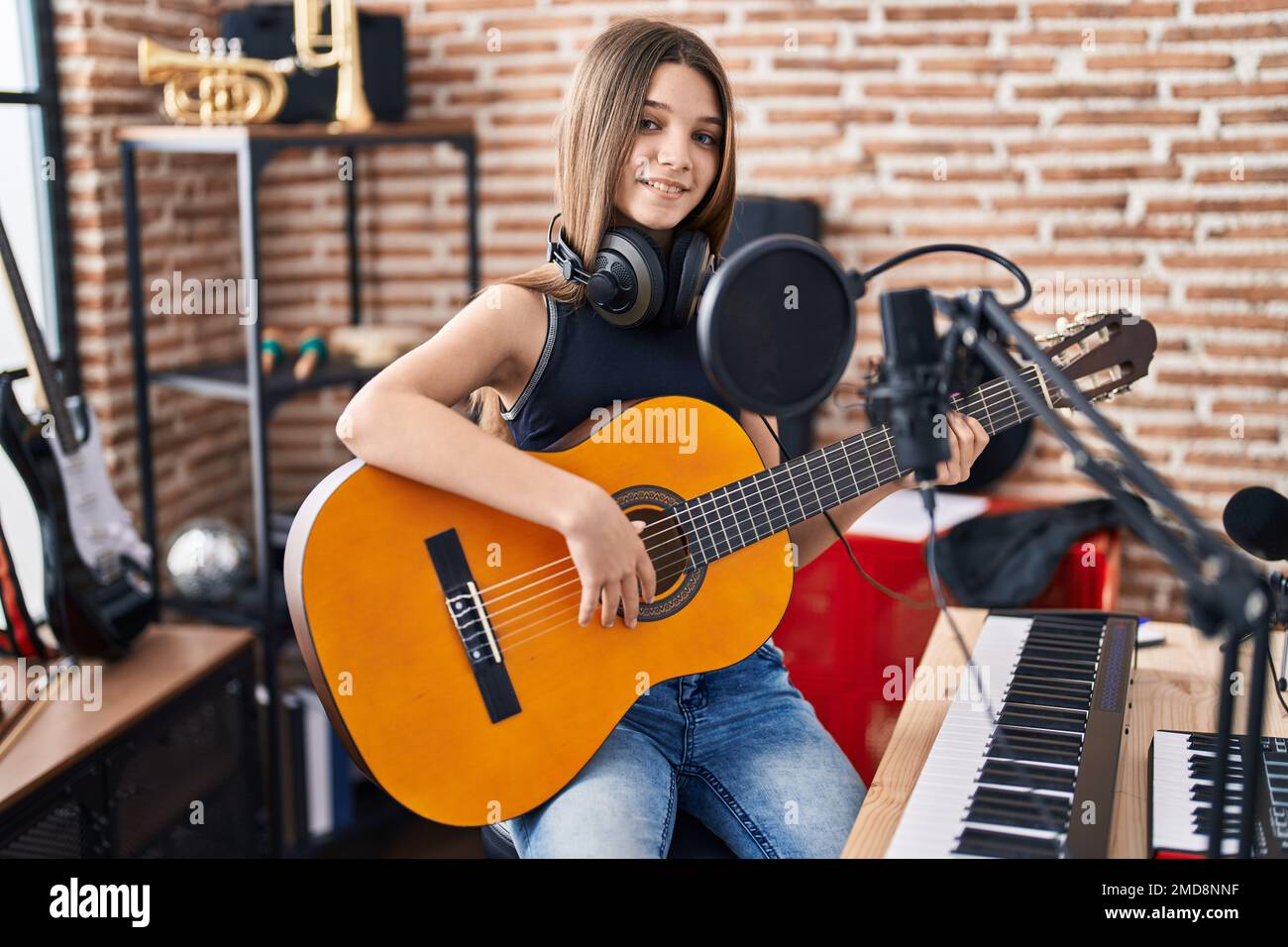 Adorable girl musician singing song playing classical guitar at music ...
